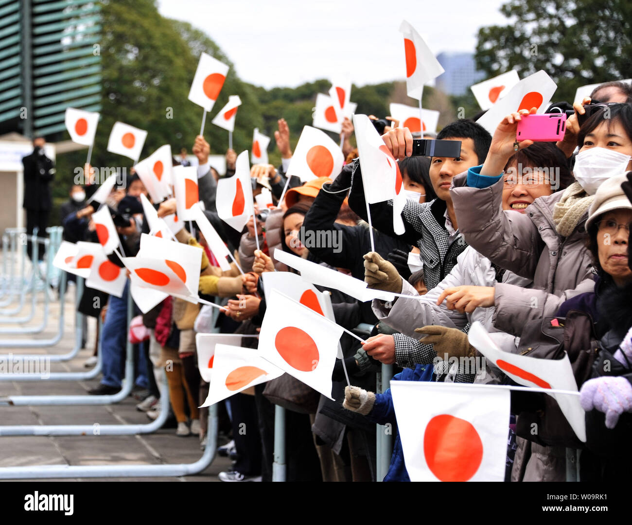 Well-wishers wave Japan's national flag during a birthday greeting for ...