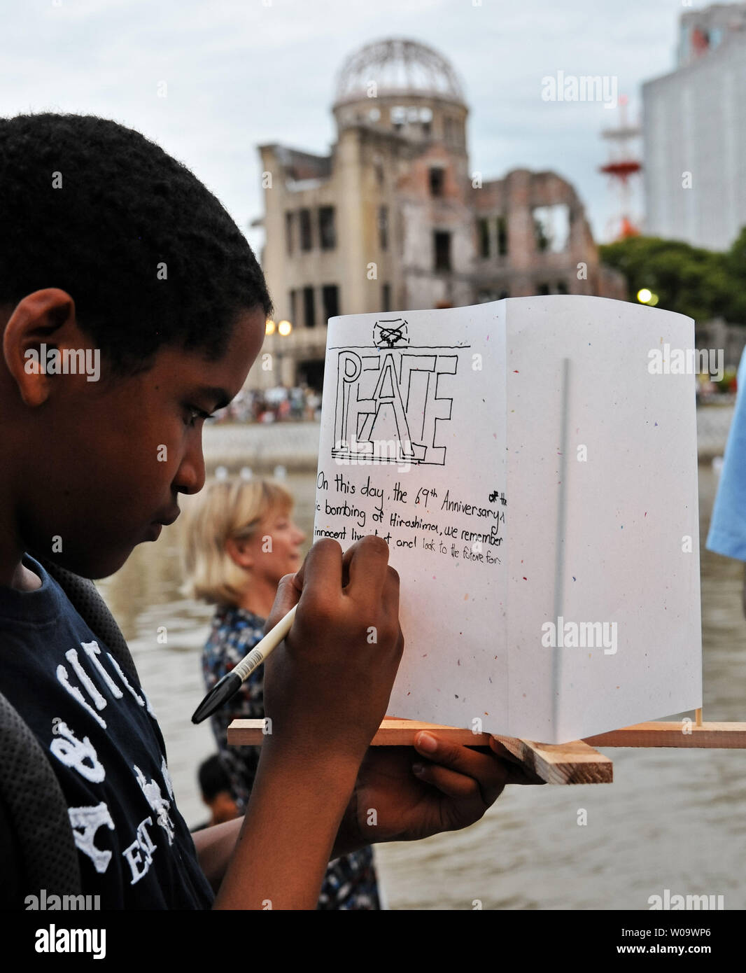 People float colorful paper lanterns into the Motoyasu River in front ...