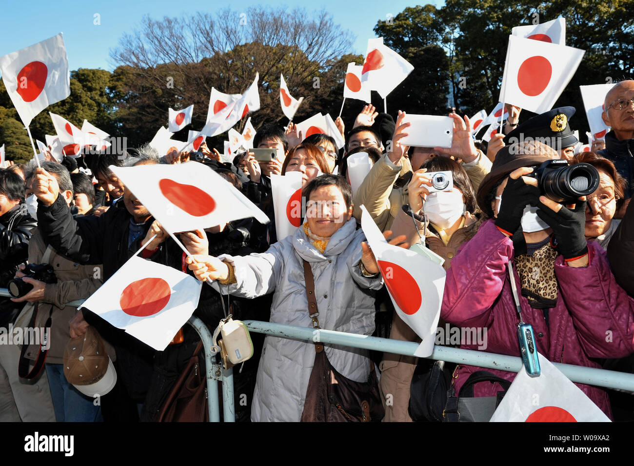 Well-wishers wave Japan's national flag during a birthday greeting for ...