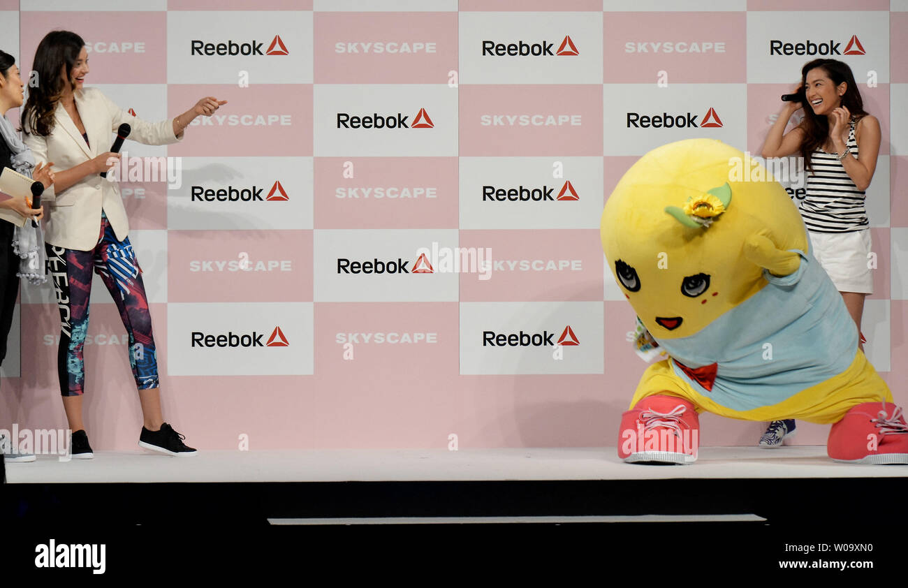Model Miranda Kerr (L) dances with Japanese popular mascot character ...