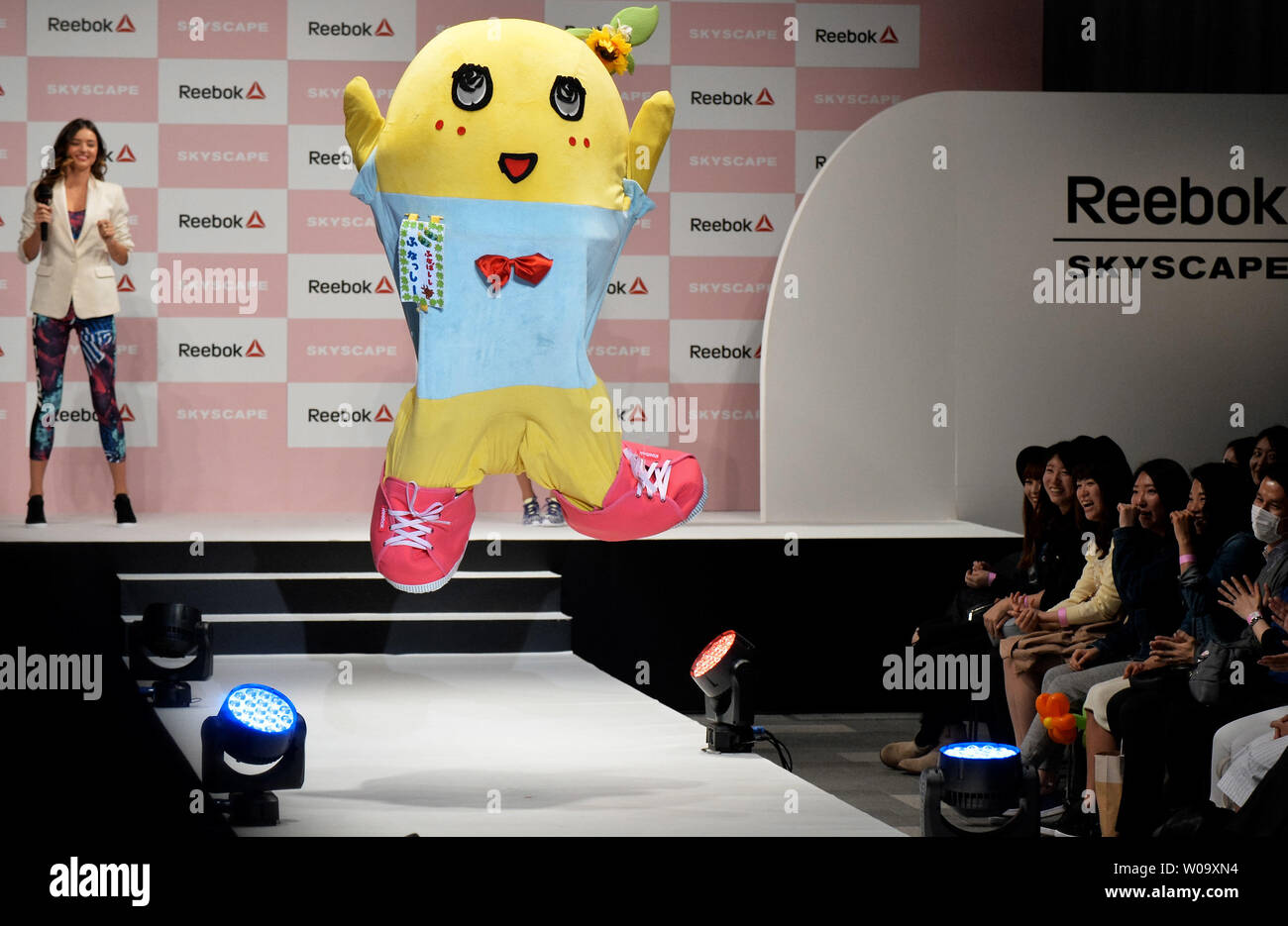 Model Miranda Kerr (L) dances with Japanese popular mascot character ...