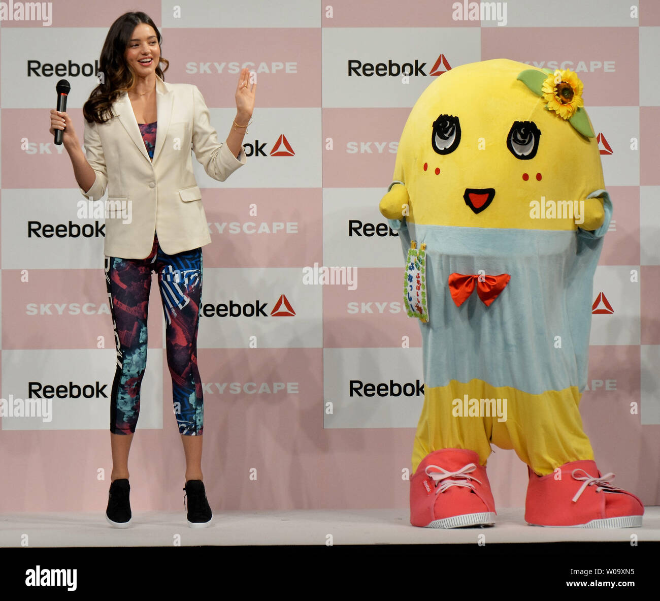 Model Miranda Kerr (L) dances with Japanese popular mascot character ...