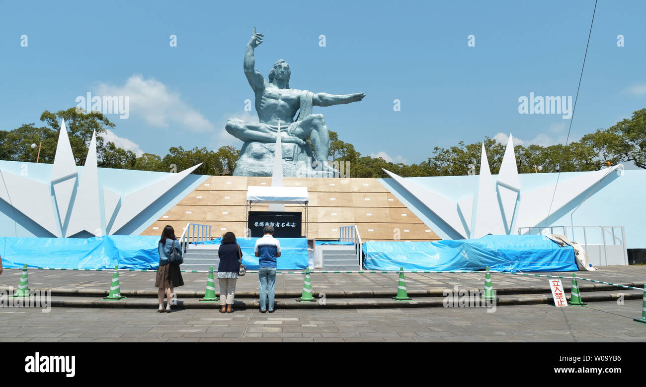 People pray for atomic bomb victims in front of the Peace Statue at the ...