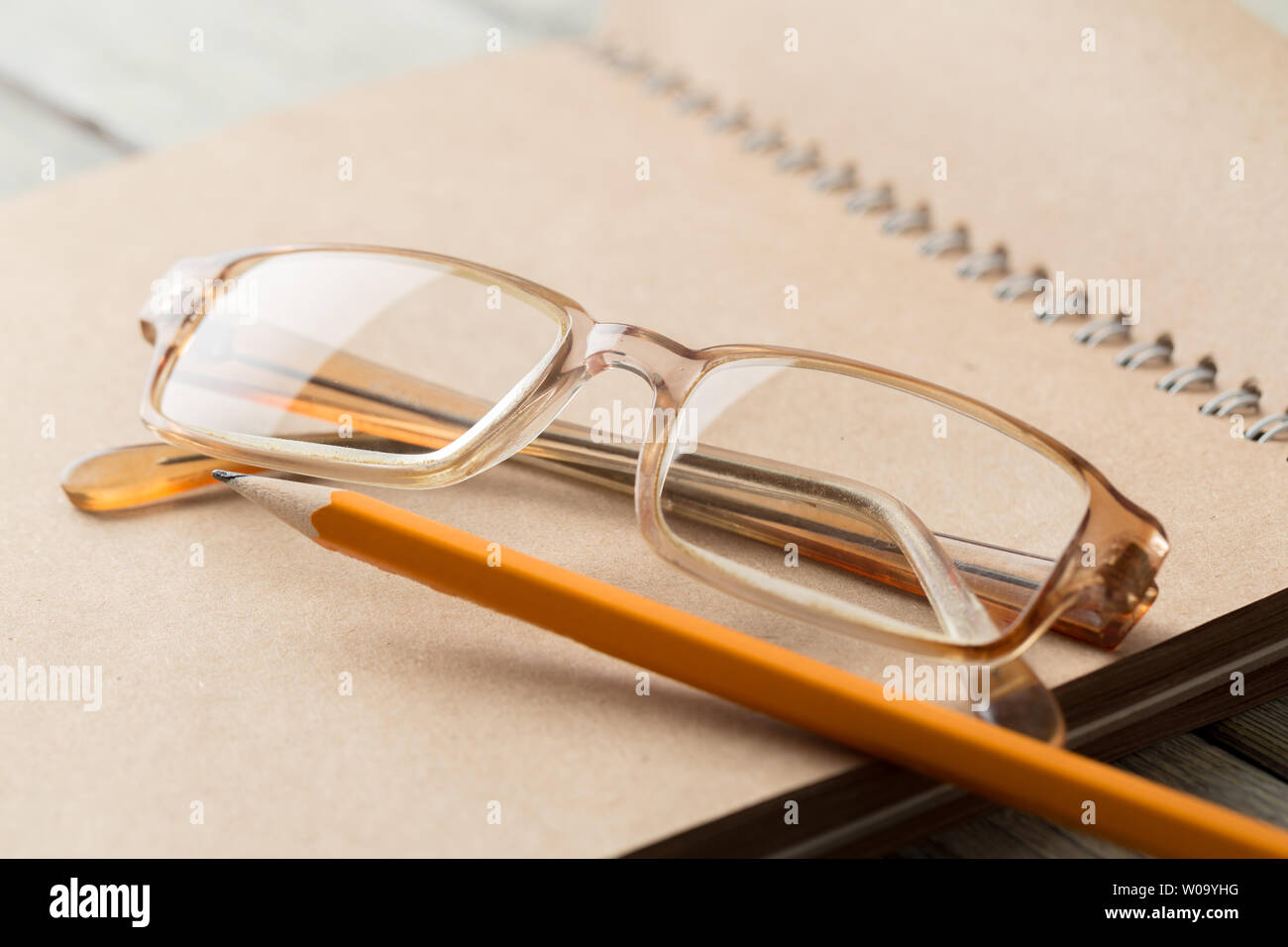 notepad and eyeglasses on the table Stock Photo - Alamy