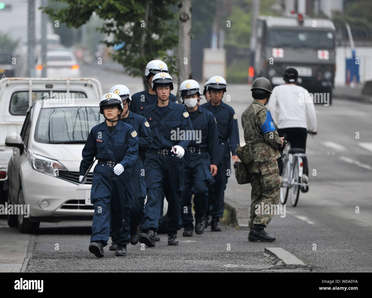 Members of Kumamoto prefecture Police patrol the street in Kumamoto ...
