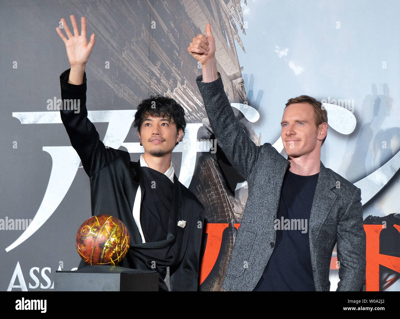 Actor Michael Fassbender(R) and Japanese actor Takumi Saito attend the ...