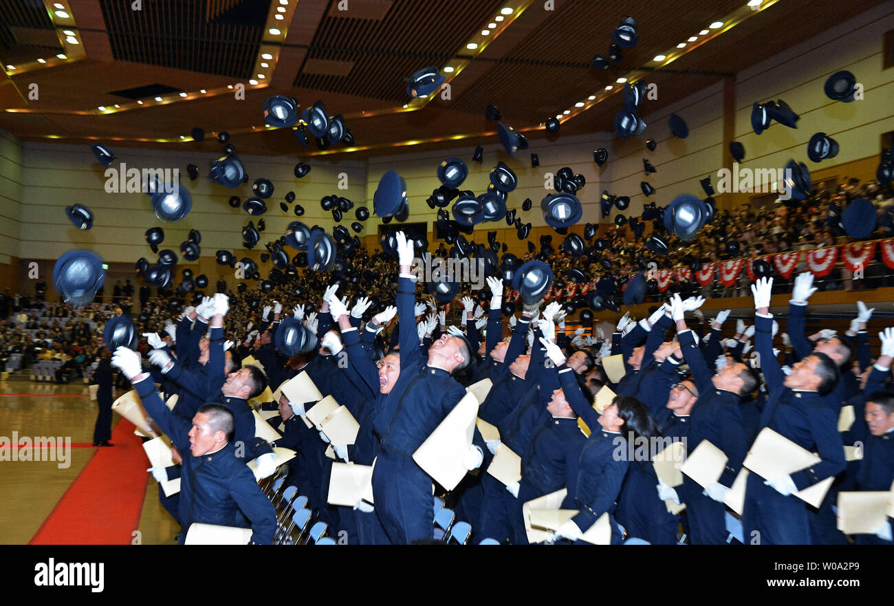 Graduates of Japan's National Defense Academy throw their caps in the ...