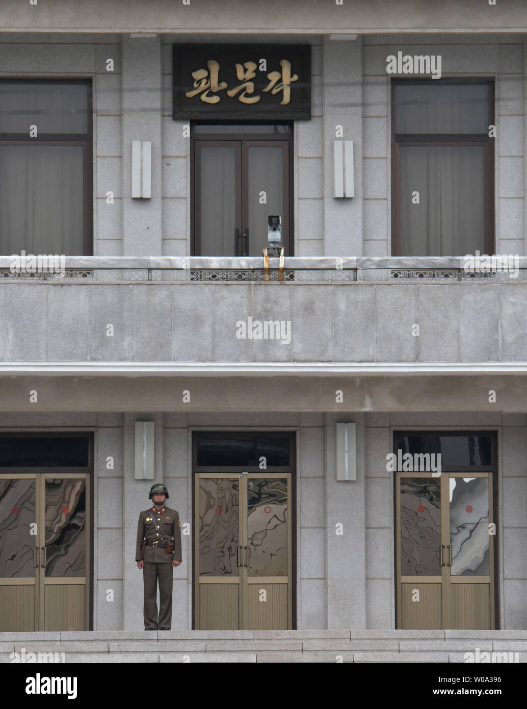 A North Korean soldiers stands watching the South side at the joint ...
