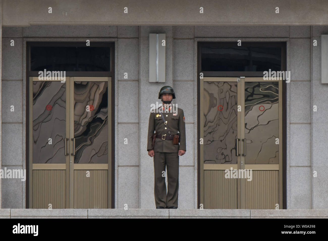A North Korean soldiers stands watching the South side at the joint ...