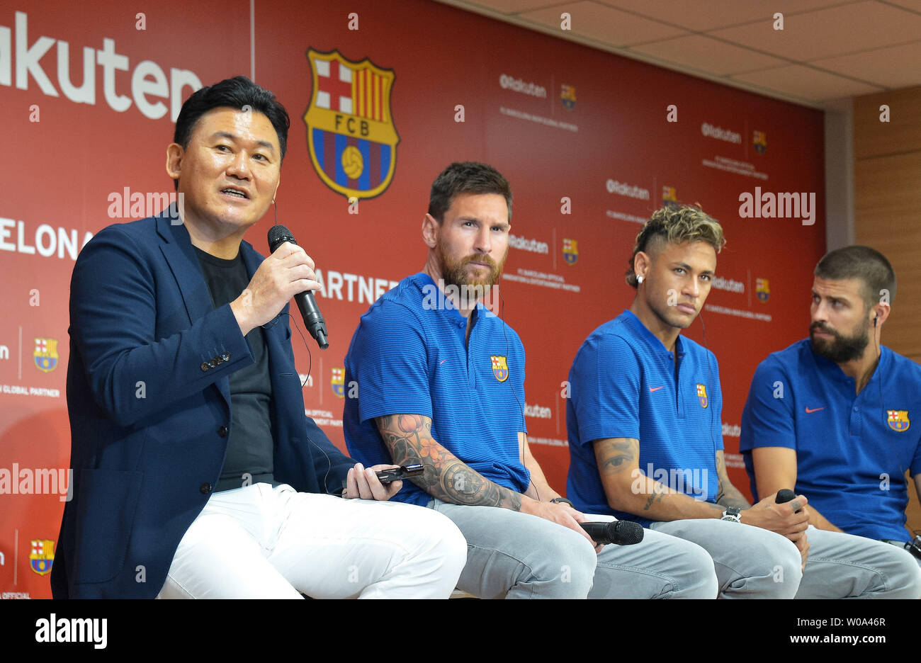 (L-R) CEO of Rakuten, Inc, Hiroshi Mikitani, Lionel Messi, Neymar Jr ...