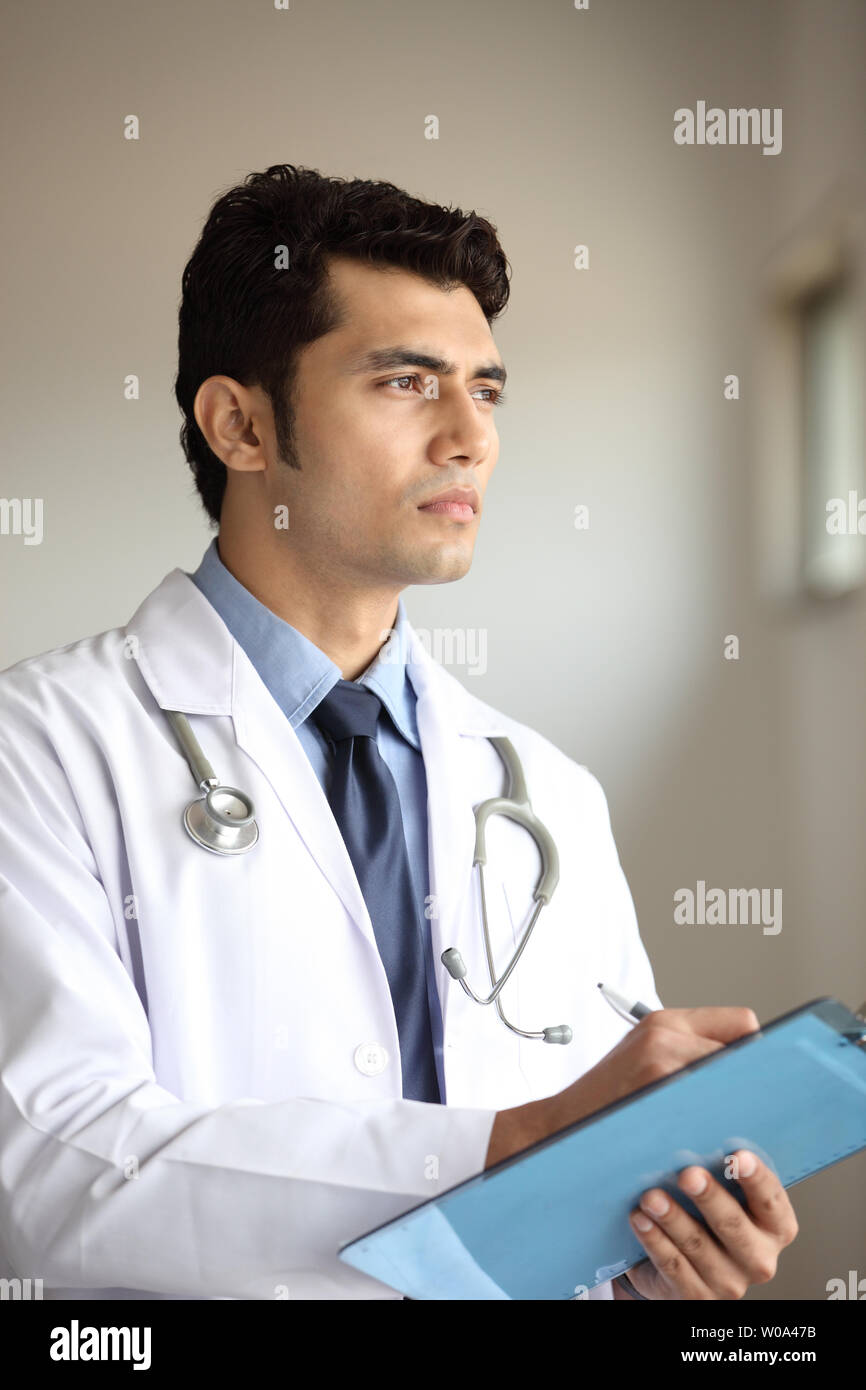 Indian male doctor writing prescription Stock Photo - Alamy