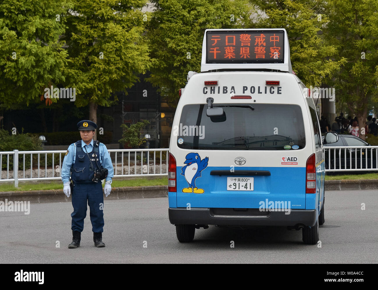 Members of Chiba prefecture Police stands guard in front of the Kaihin ...
