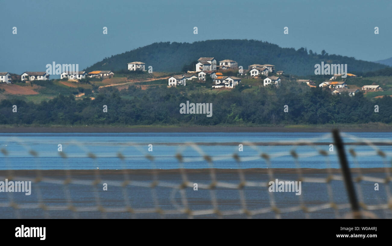 The village of Kaepung, North Korea is seen across the Imjin river and ...