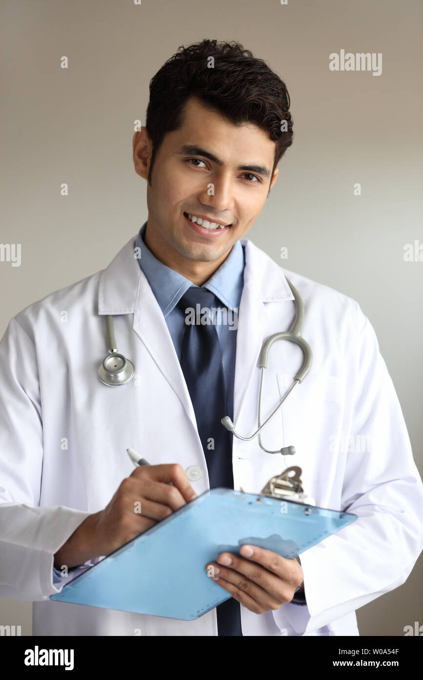 Indian male doctor writing prescription Stock Photo - Alamy
