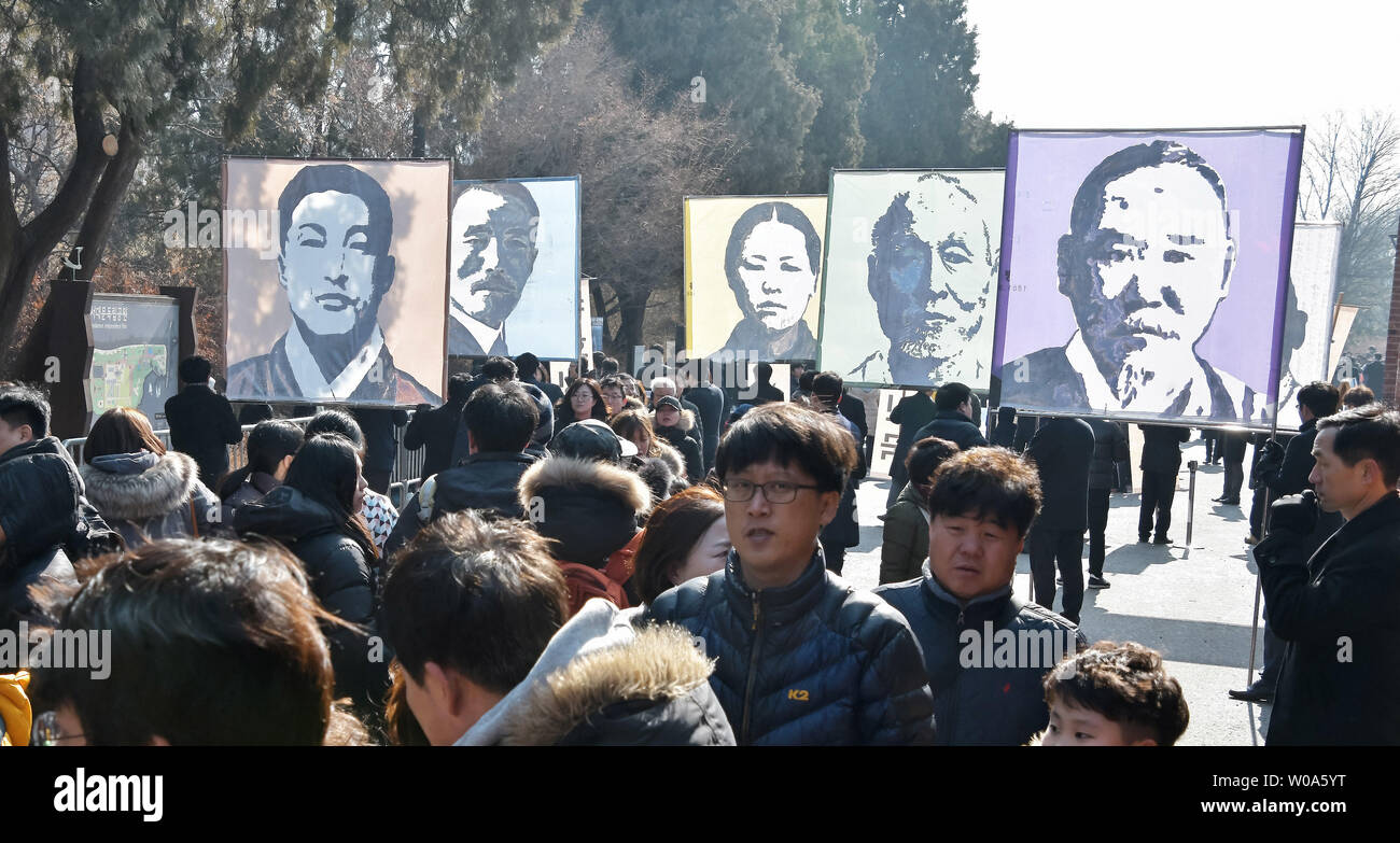 People hold some banner during a ceremony of the 99th anniversary of ...