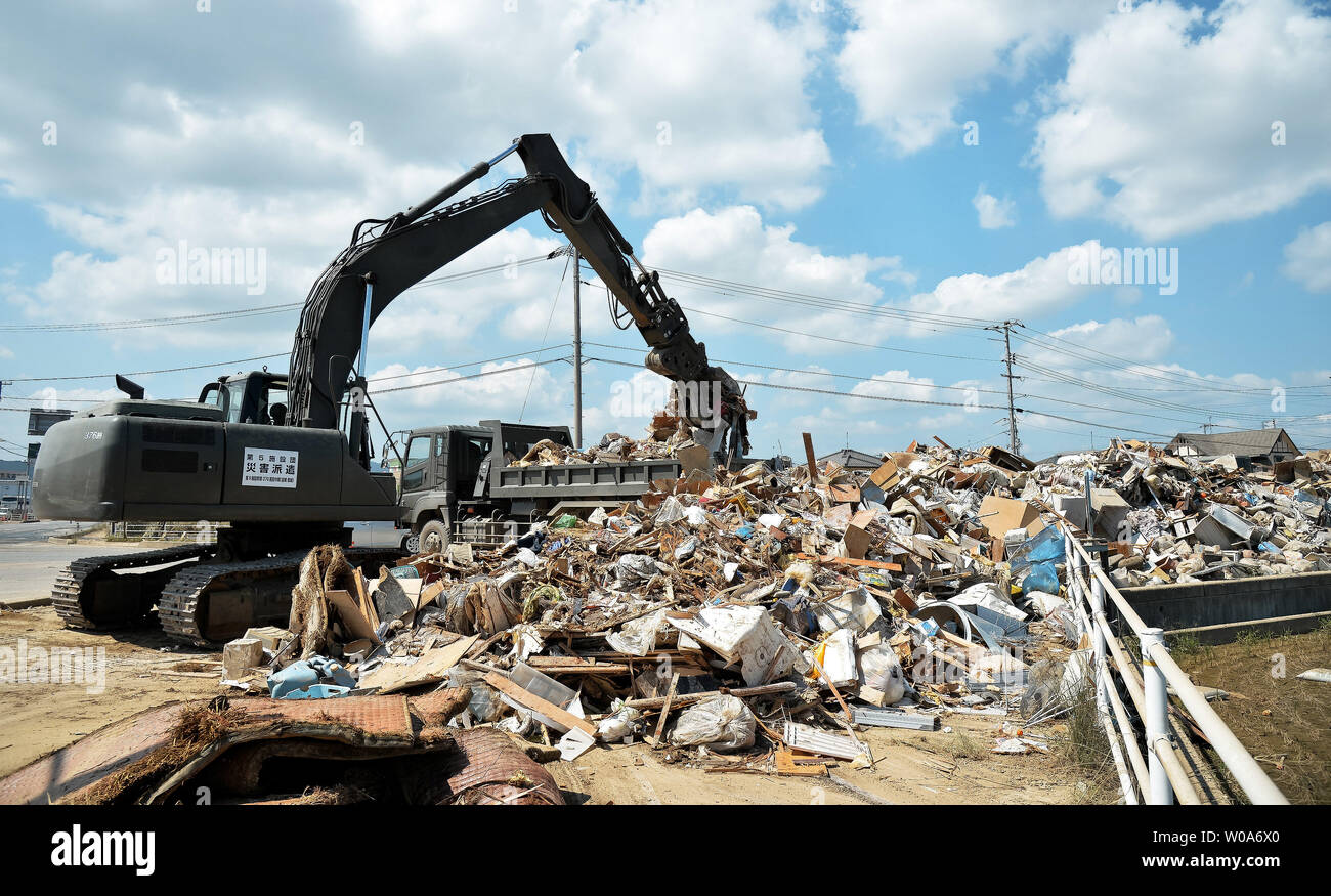 Members of Japan Ground Self-Defense Force remove the piled up rubbish ...