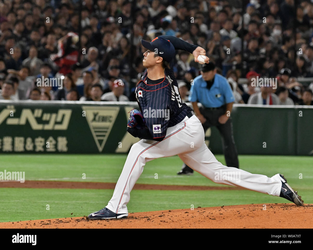 Naoyuki Uwasawa, pitcher of Japan national team, throws in the first ...