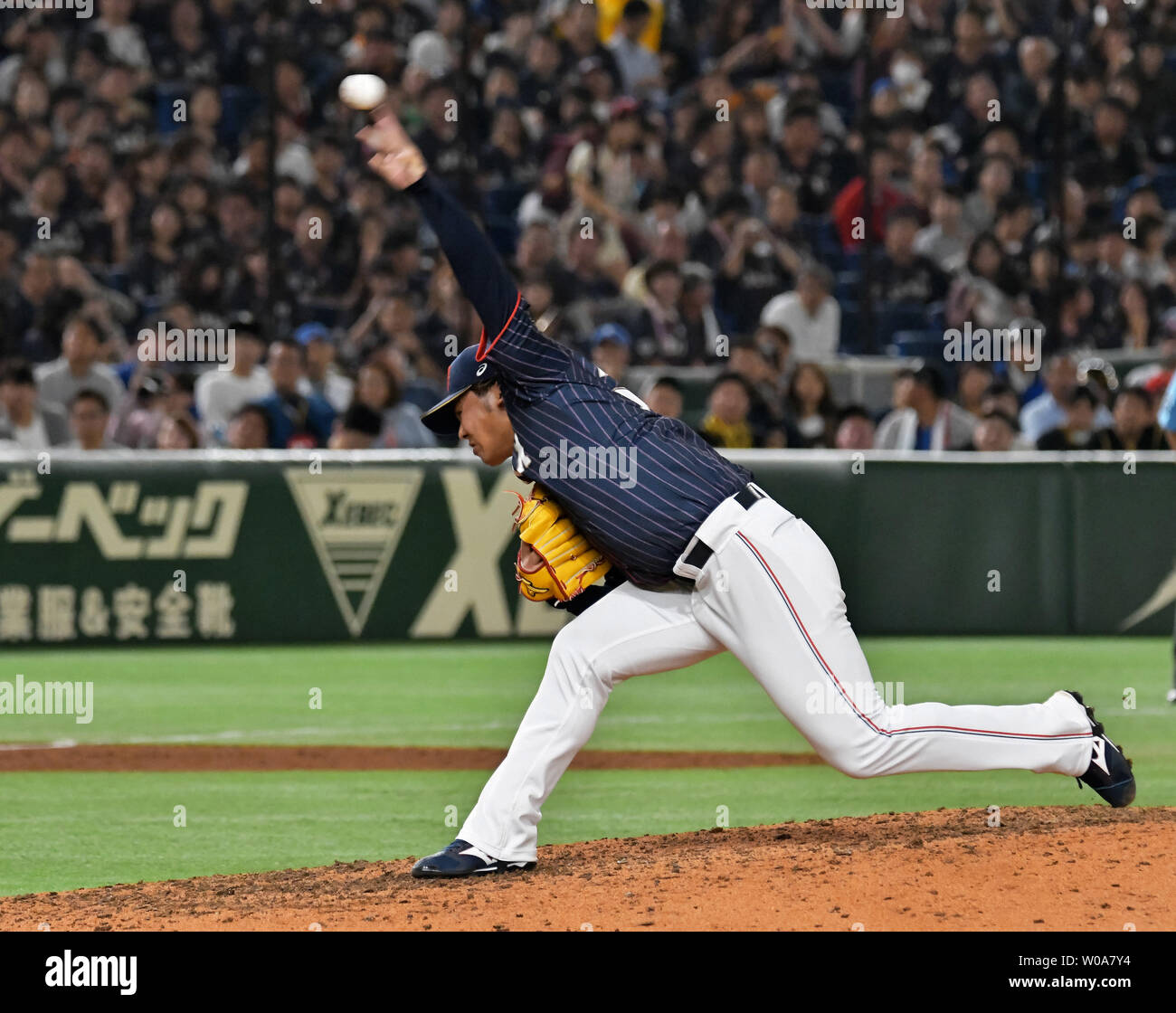 Naoyuki Uwasawa, pitcher of Japan national team, throws in the sixth ...
