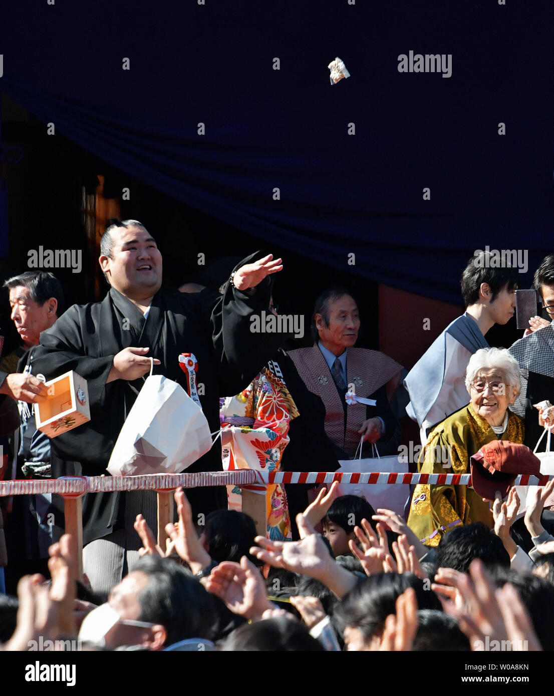 Sumo wrestler Ozaki, Kotoshogiku throws beans during the bean-throwing ...