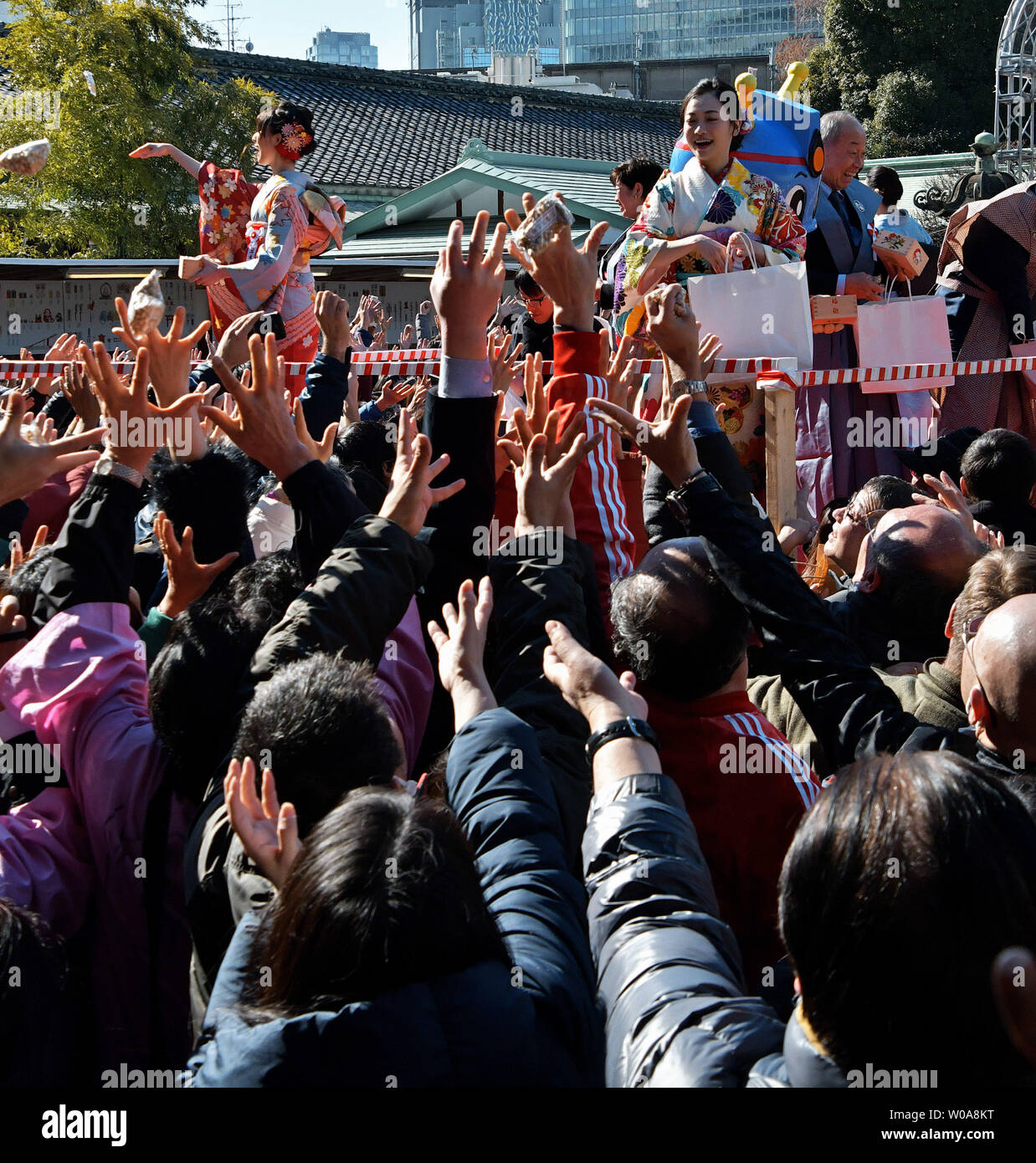 Japanese singer Ai Nishida(R) throws beans during the bean-throwing ...