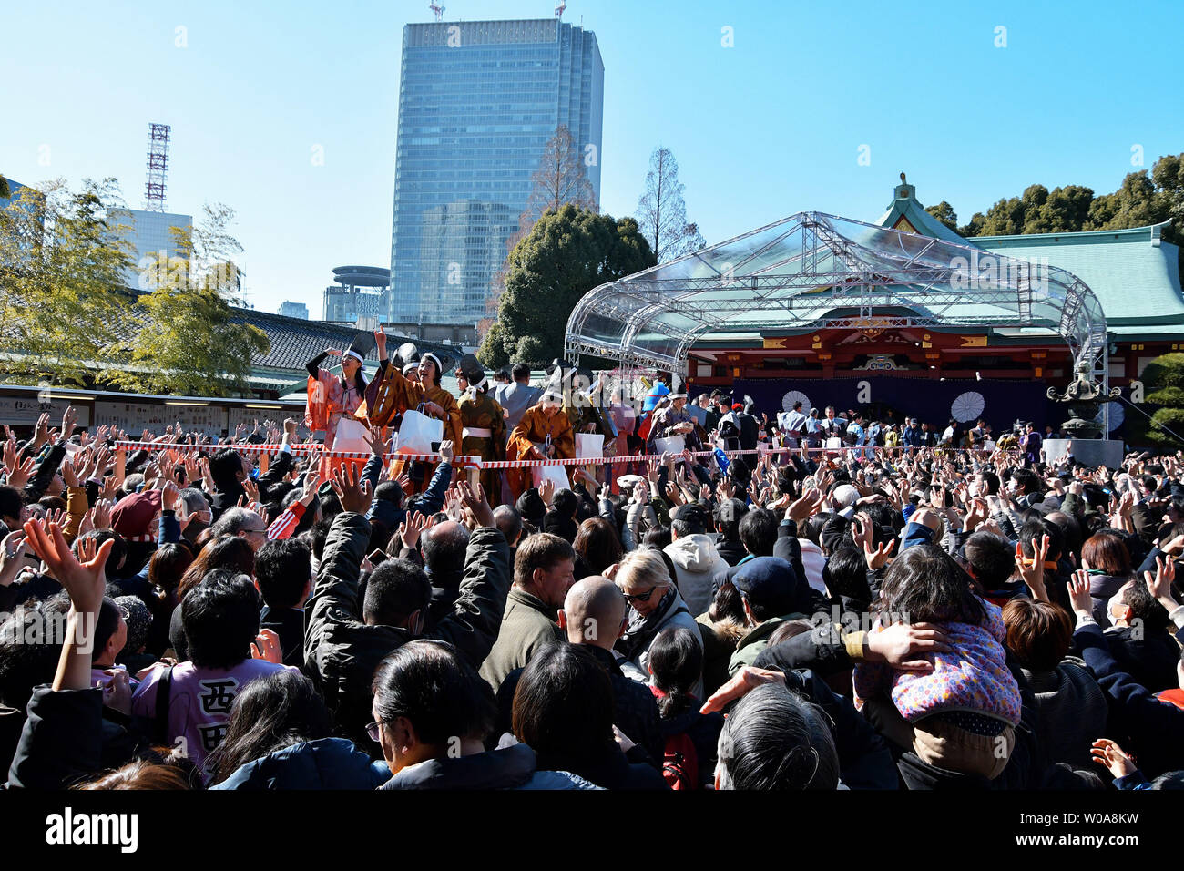 People try to catch bags containing lucky beans during the bean ...