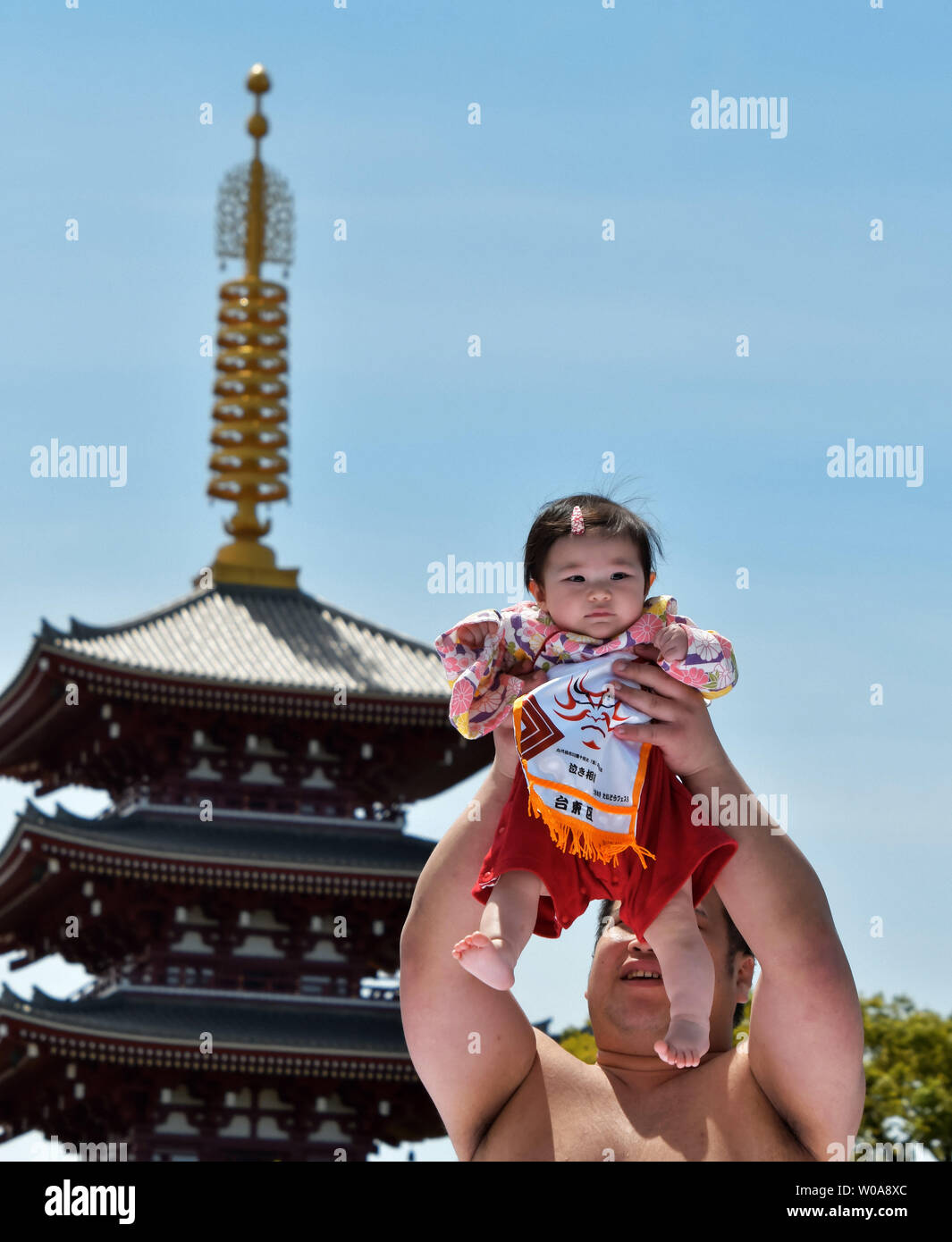 A baby doesn't cry as it is lifted by an amateur sumo wrestler is seen ...