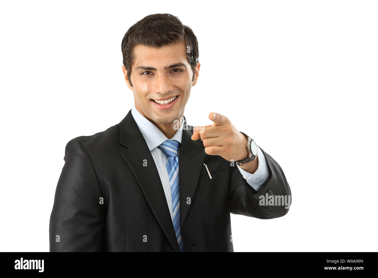 Portrait of a businessman pointing and smiling Stock Photo - Alamy