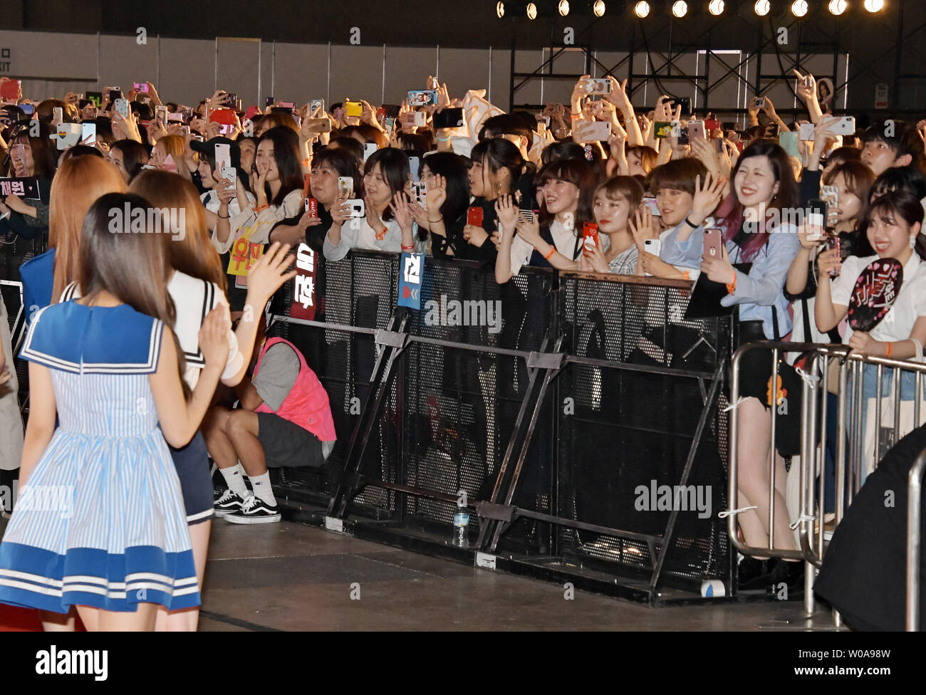Members of South Korean and Japanese girl group IZ*ONE pose for ...
