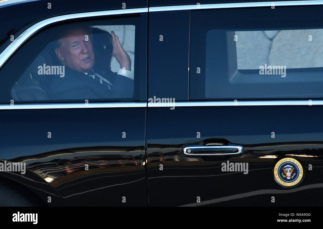 U.S. President Donald Trump waves from the presidential cadillac ...