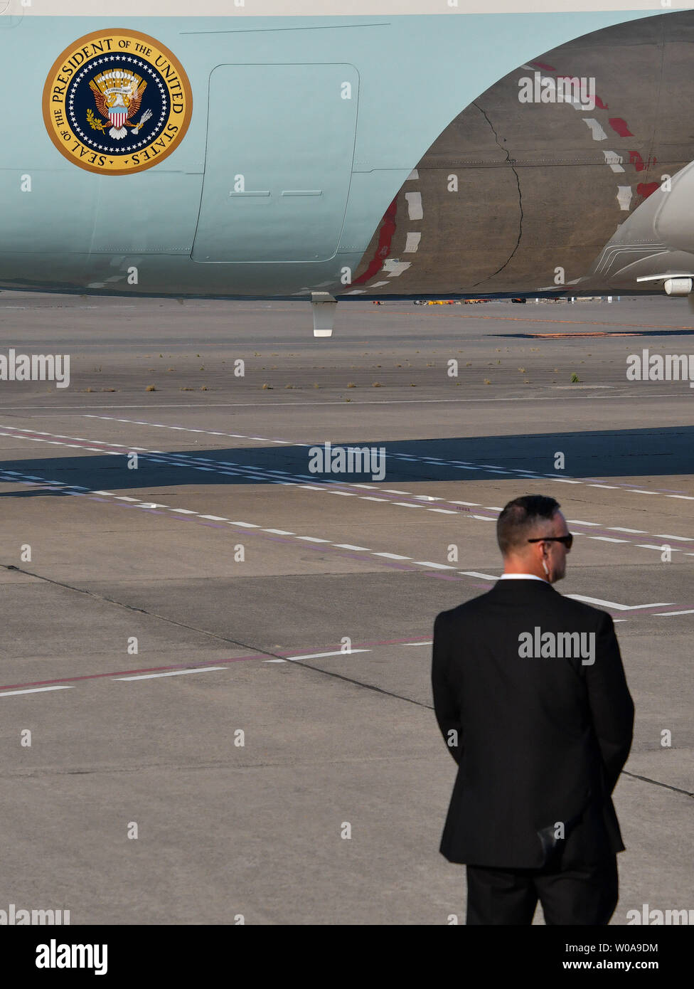 Secret service officers stand guard at Tokyo International Airport in ...