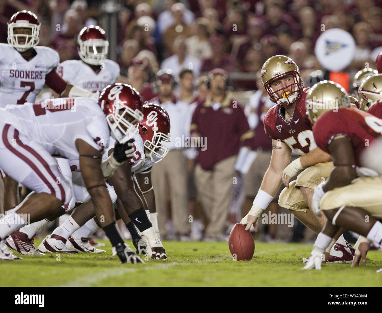 Florida State center center Bryan Stork (52) locks over his shoulder ...