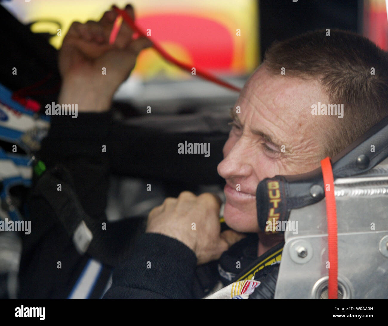 Mark Martin buckles himself into his race car as he readies to qualify ...