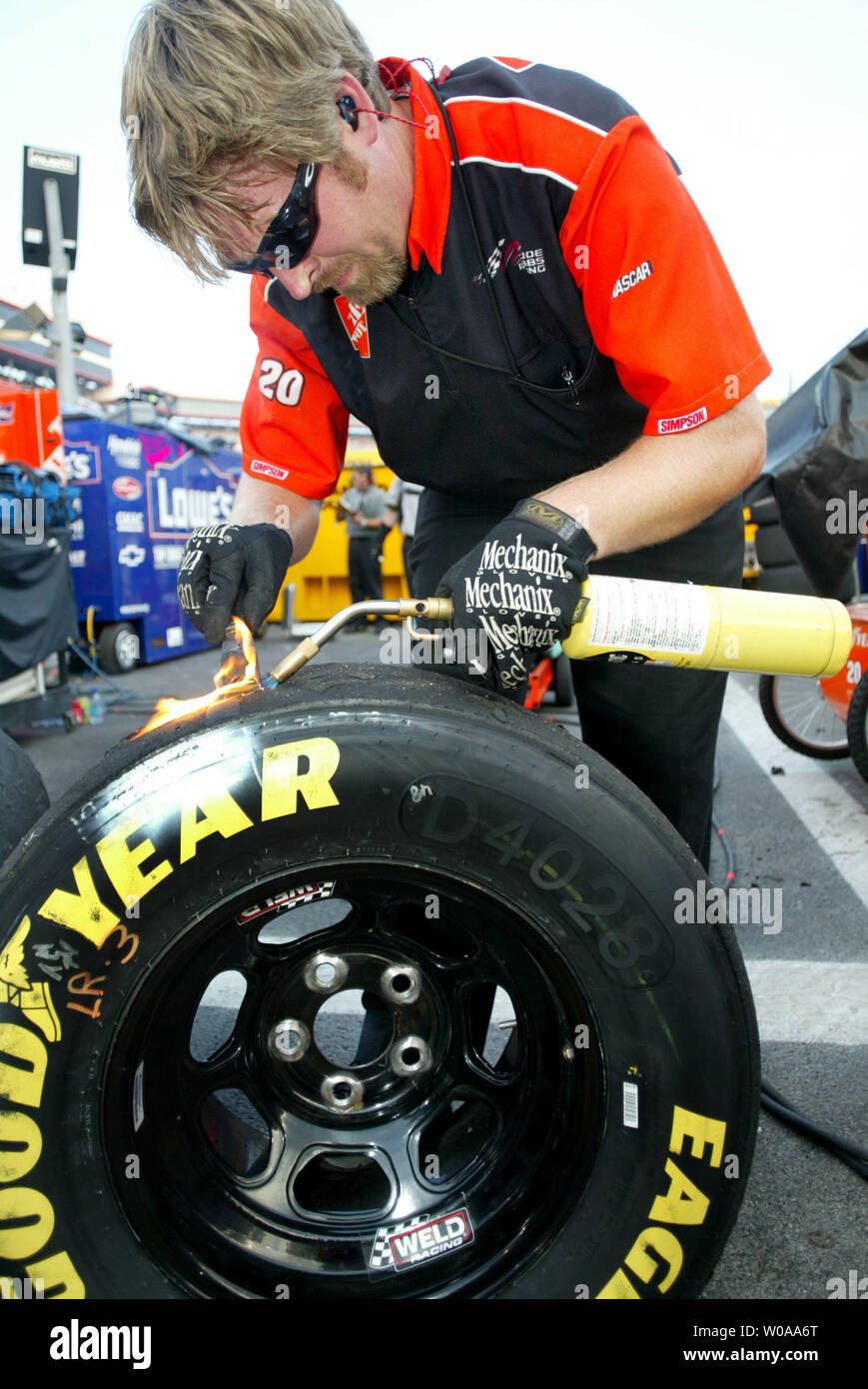 Byron Goggin of the Home Depot Chevrolet team uses a blow torch to ...