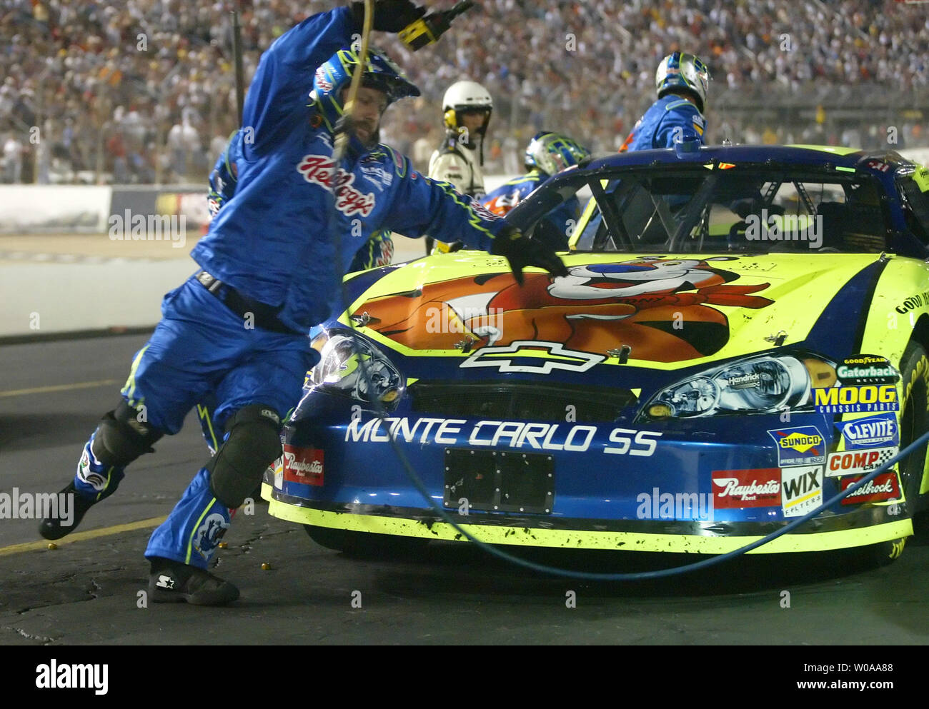 The Kellogg's Chevrolet pit crew hurries through a pit stop for driver ...