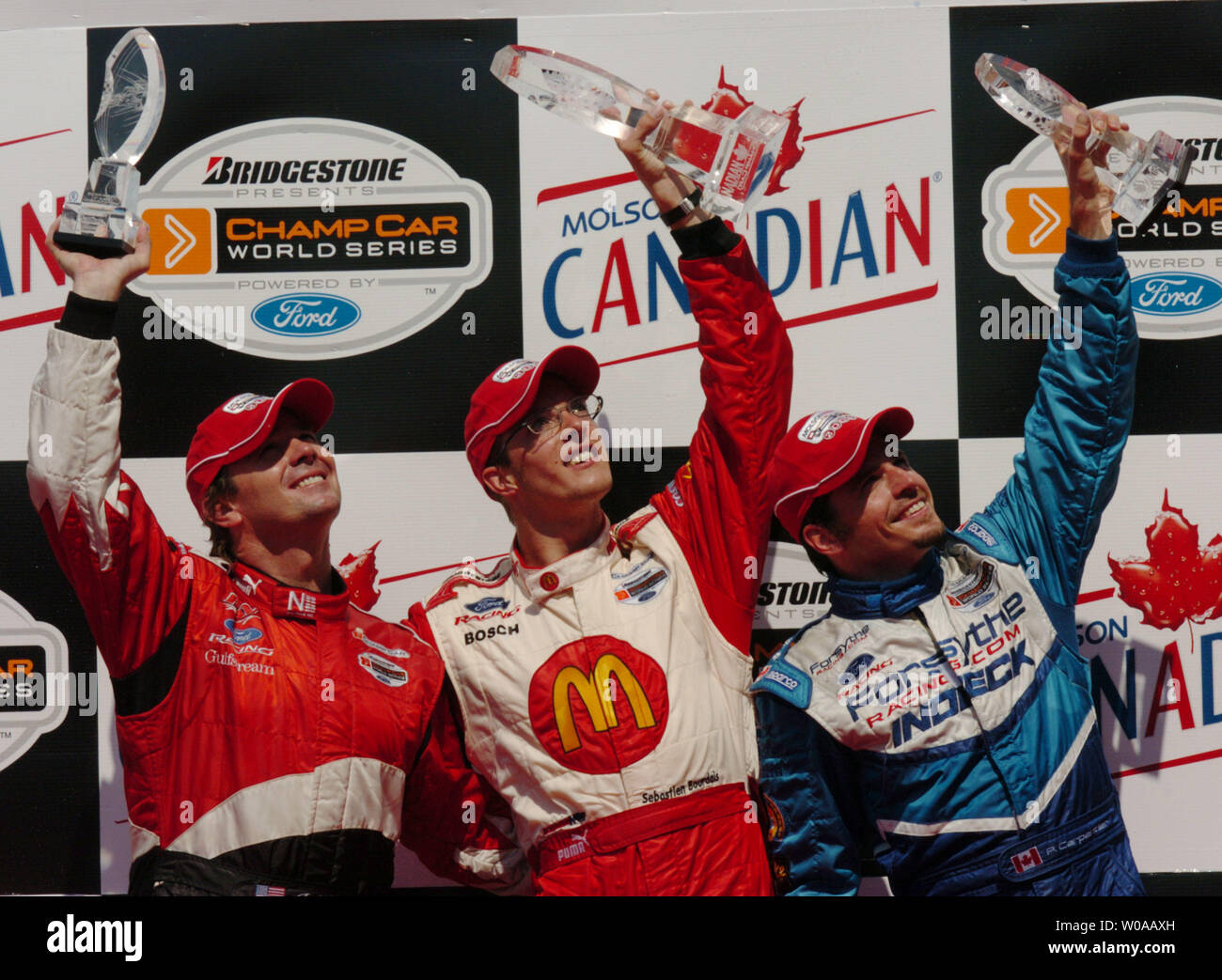 (L-R) Runner-up Jimmy Vasser, winner Sebastien Bourdais and third place ...