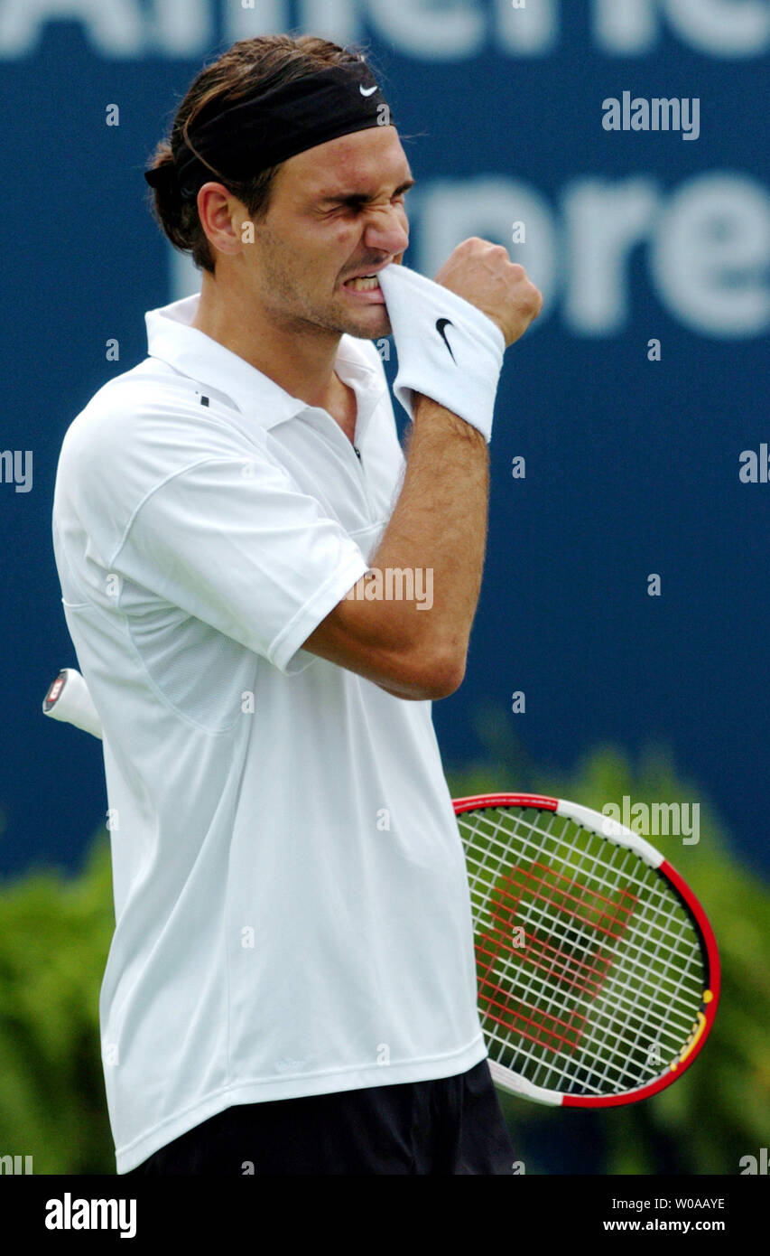 Top seed Roger Federer of Switzerland bites his wristband in ...