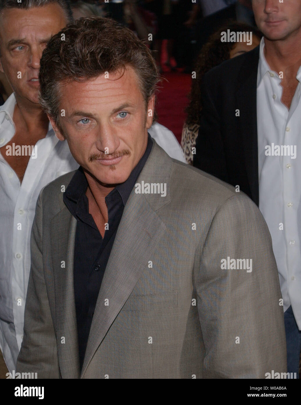 Sean Penn swept quickly by photographers on the red carpet on his way ...