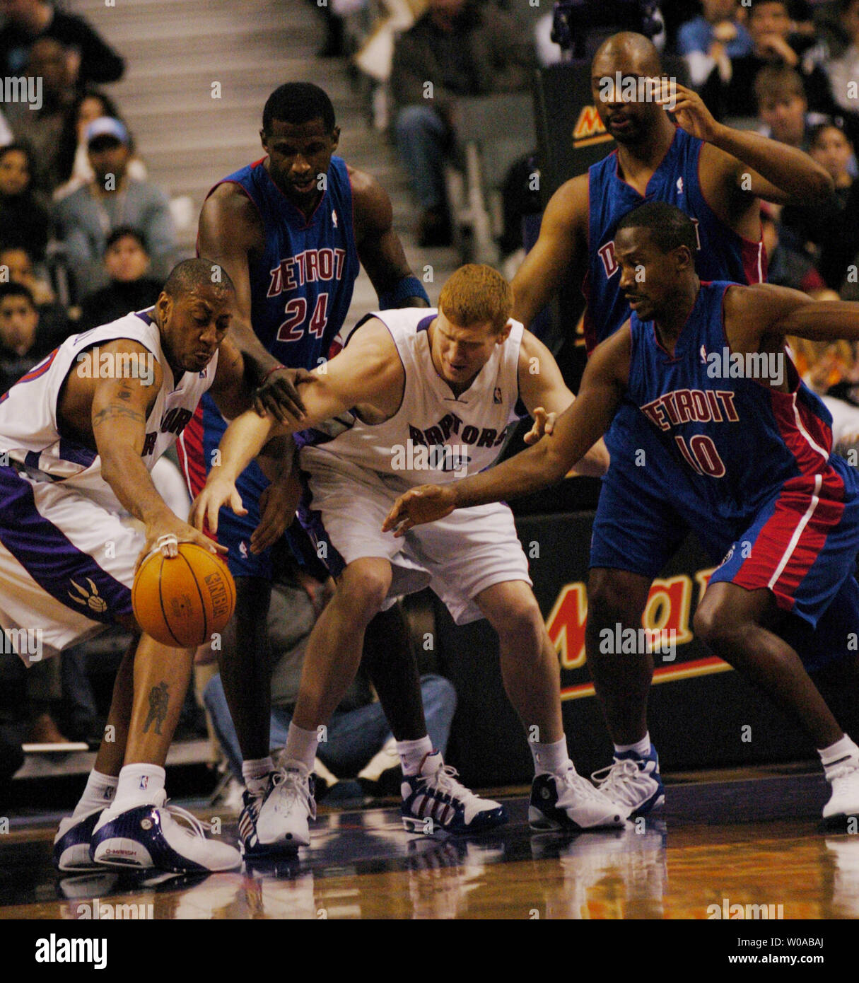 Toronto Raptors' Donyell Marshall(far left) and Matt Bonner try to get ...