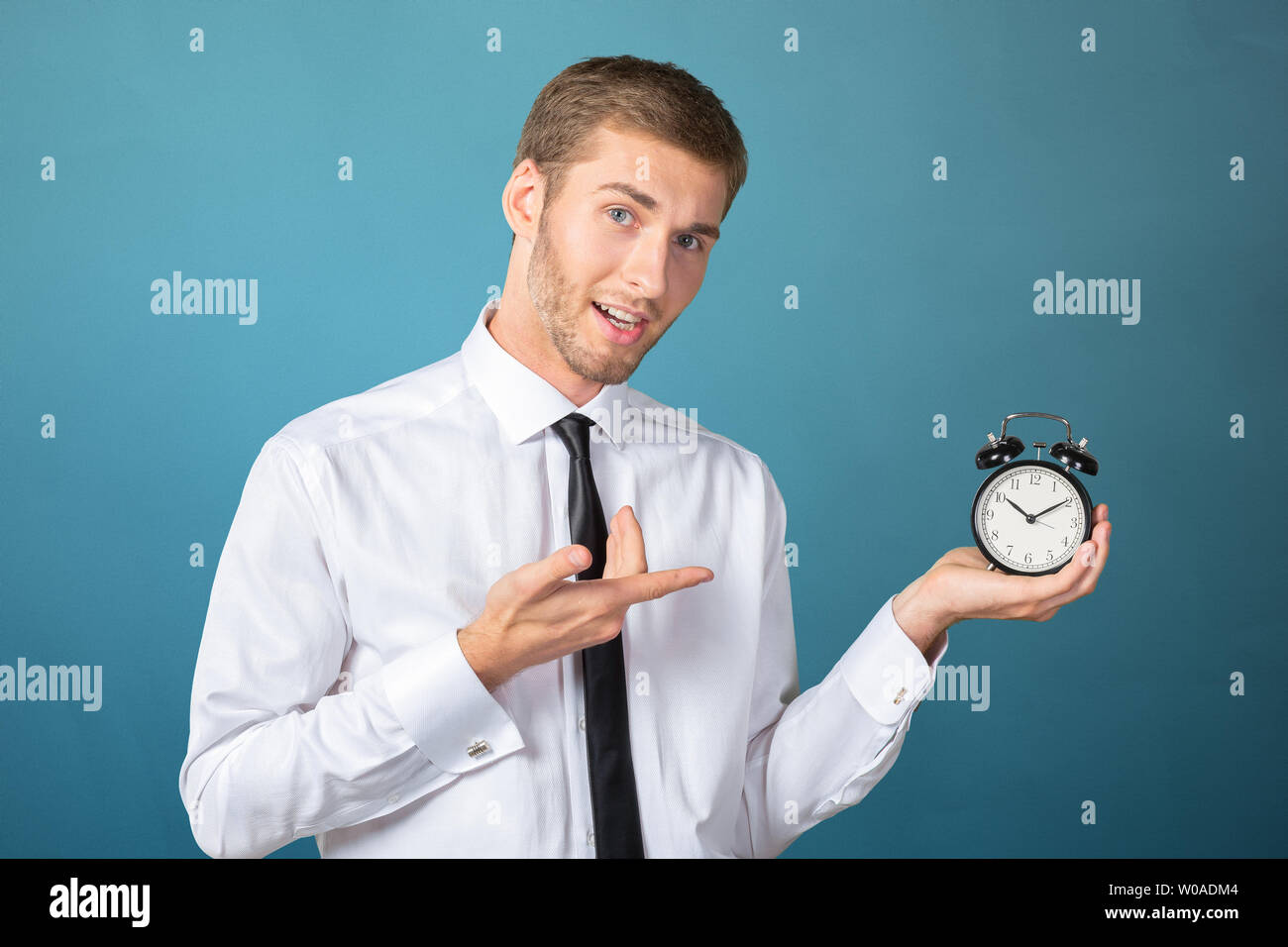 Successful businessman in formal wear pointing at clock Stock Photo - Alamy