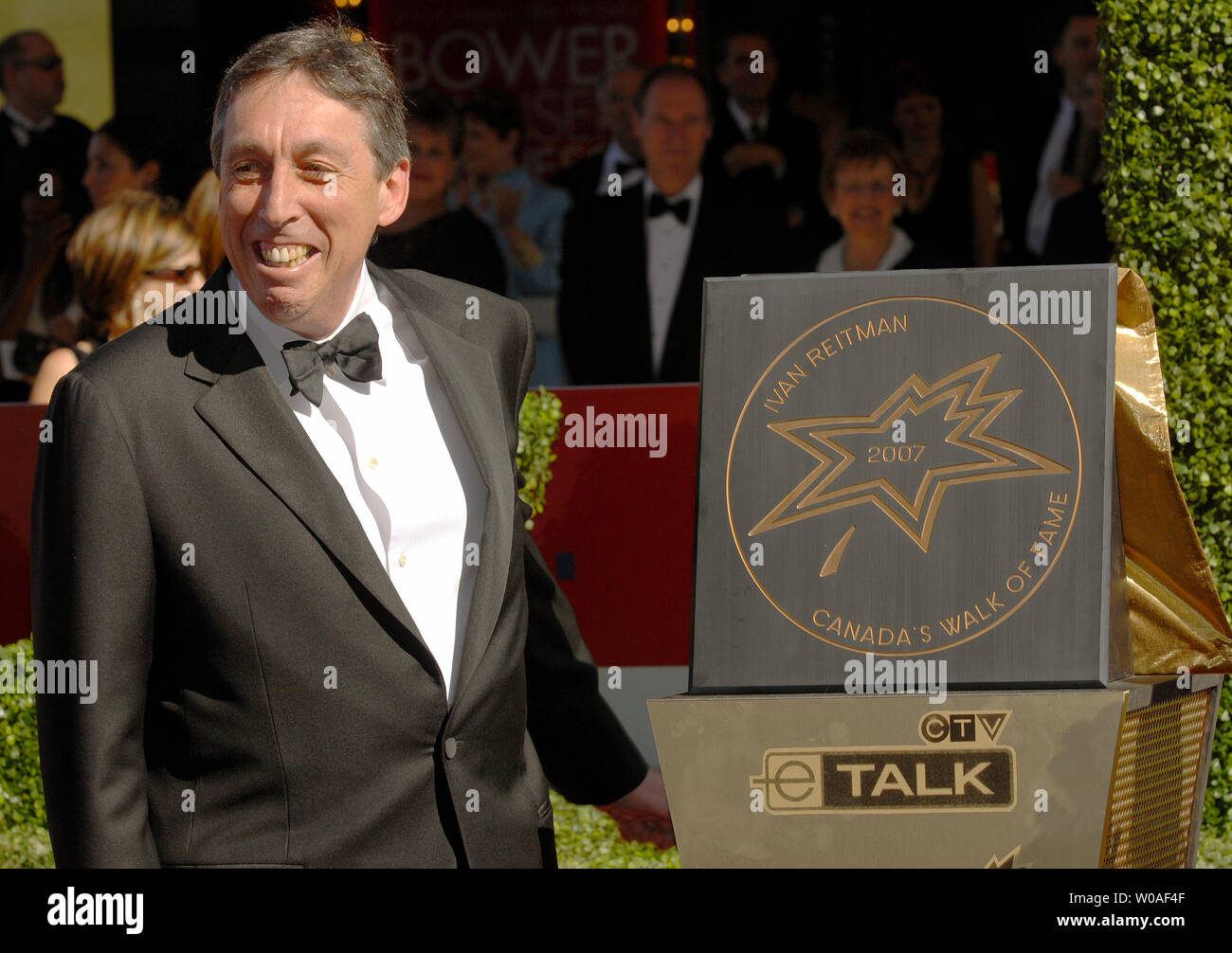 Director Ivan Reitman shows off his newly unveiled star as he is ...