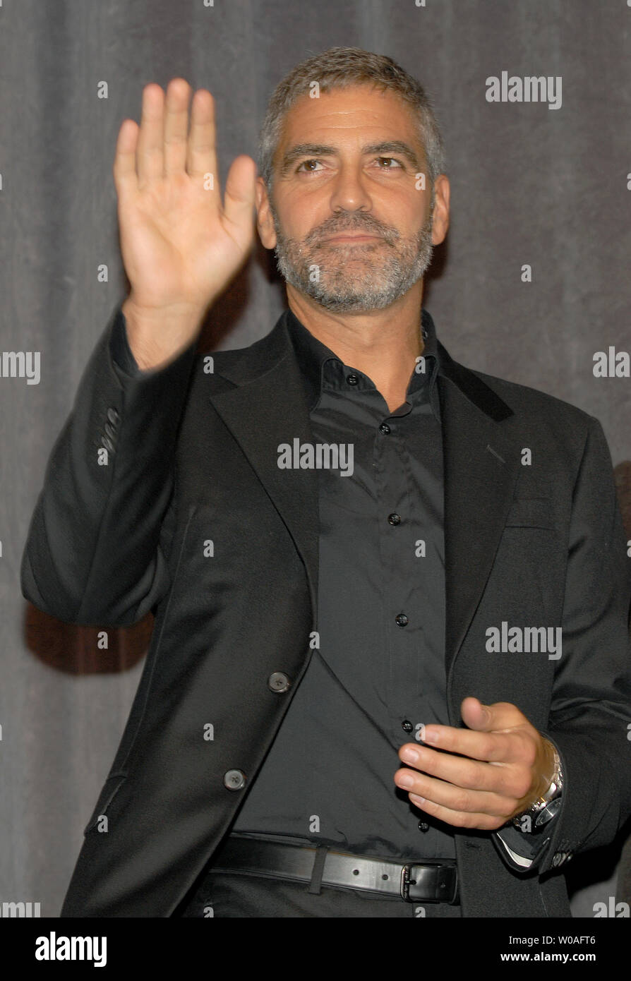 George Clooney acknowledges applause from the crowd during cast ...