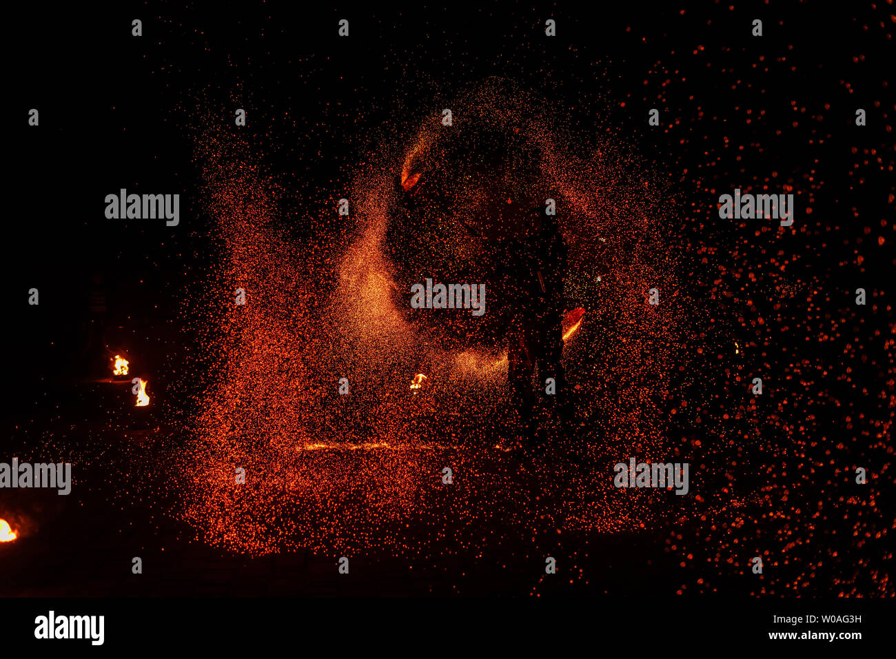 Fire show, dancing with flame, male master juggling with fireworks ...