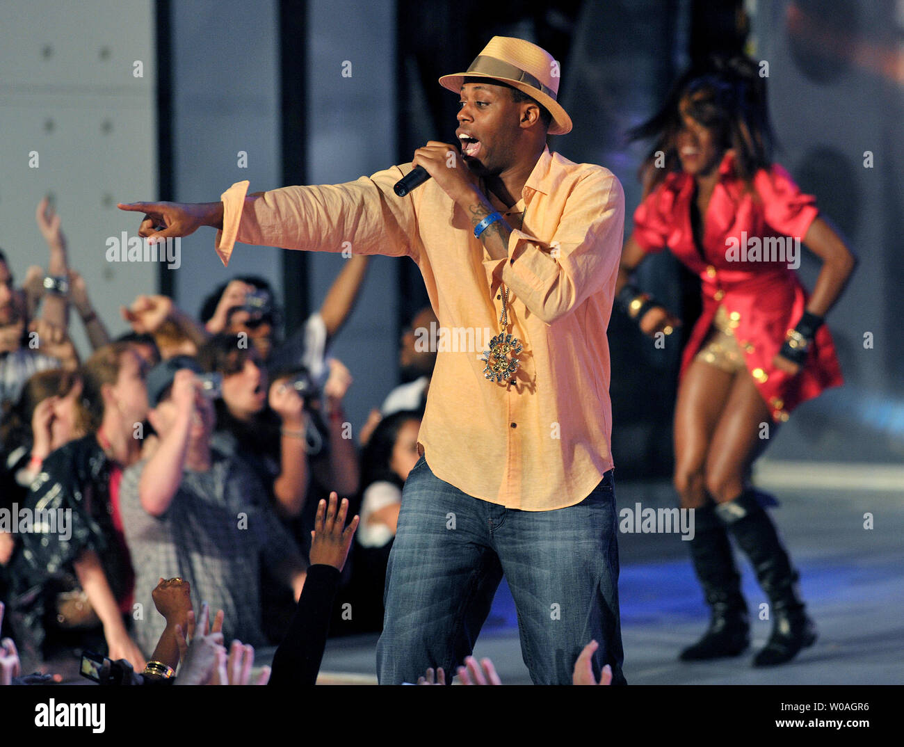 Rapper Kardinal Offishall performs on an outdoor stage before thousands ...
