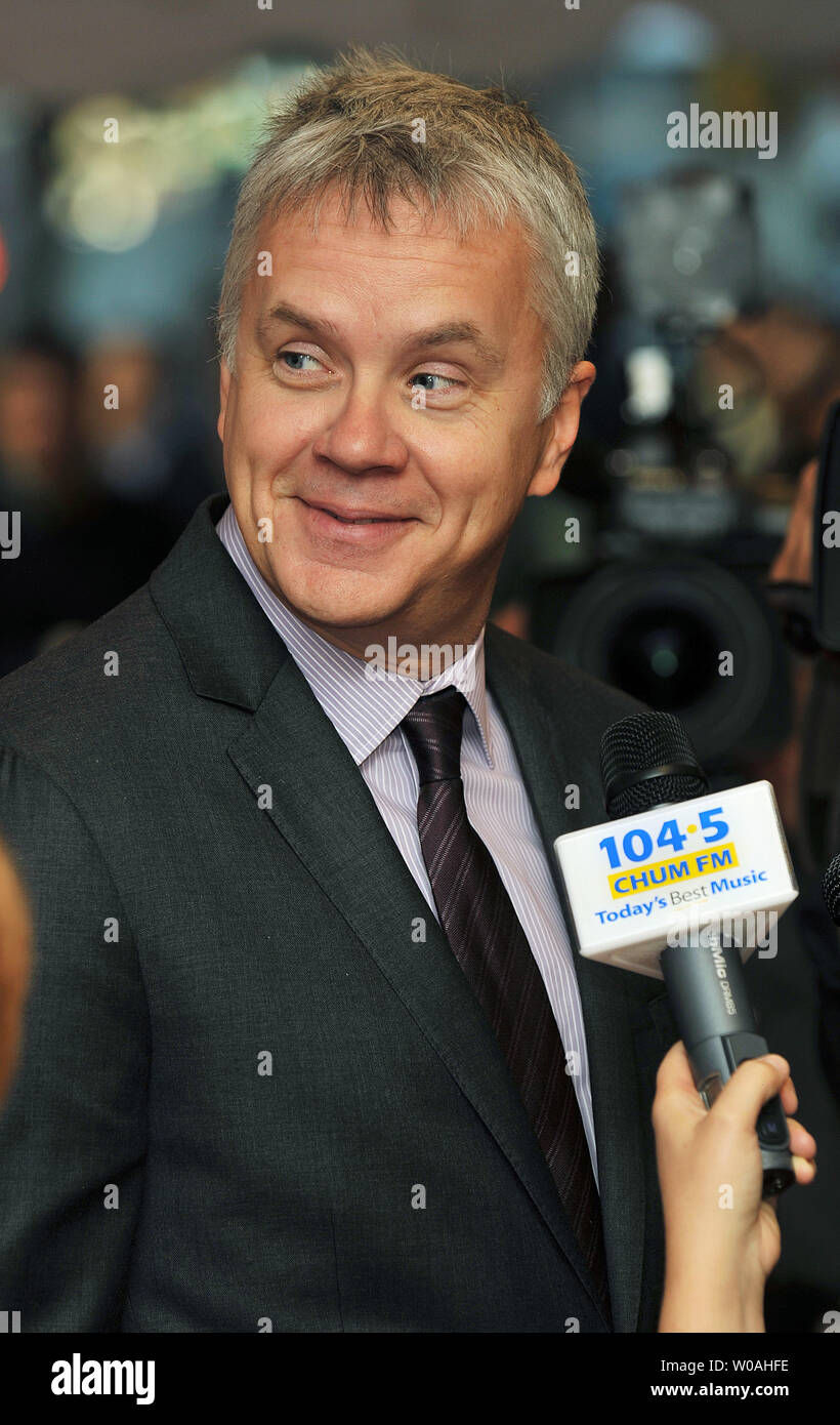Tim Robbins speaks with television reporters on the red carpet as he ...