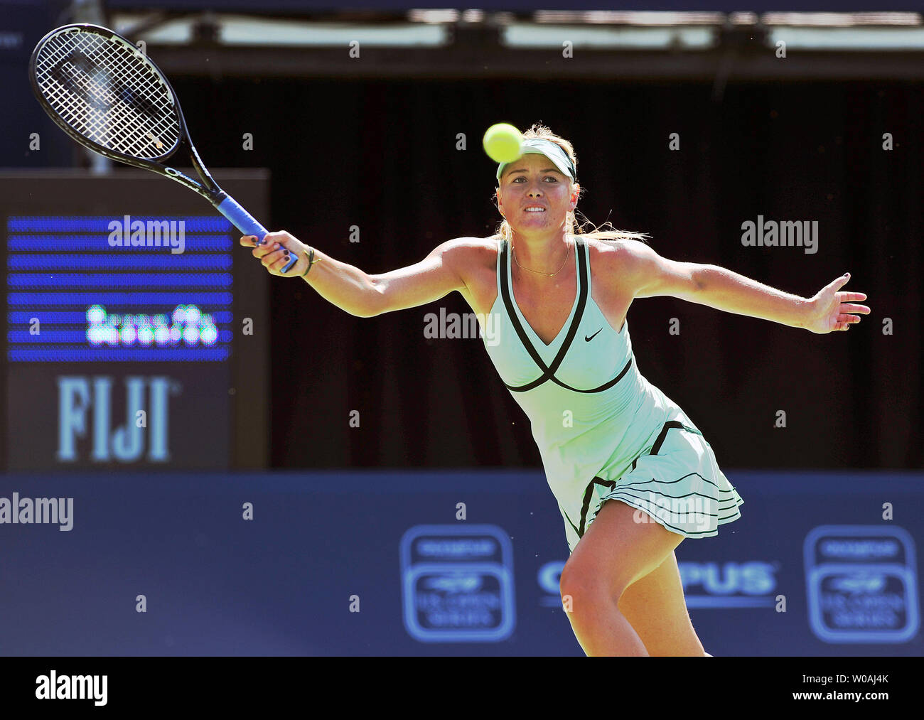 Russian star Maria Sharapova hits a forehand return against Sybille ...