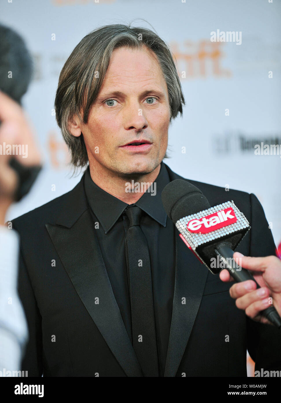 Actor Viggo Mortensen speaks with television reporters on the red ...