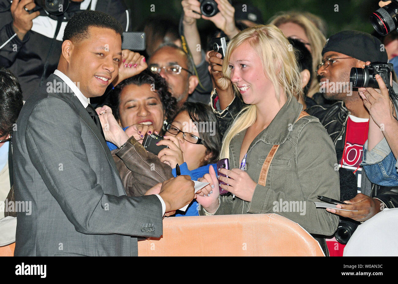 Actor Terrence Howard signs autographs for fans as he arrives for the ...