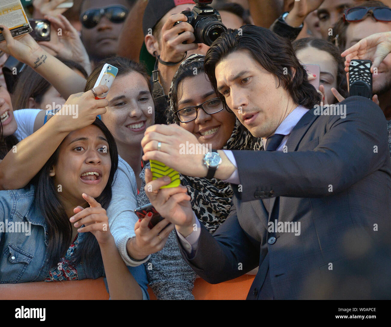Adam Driver takes a selfie with fans as he arrives for the world ...