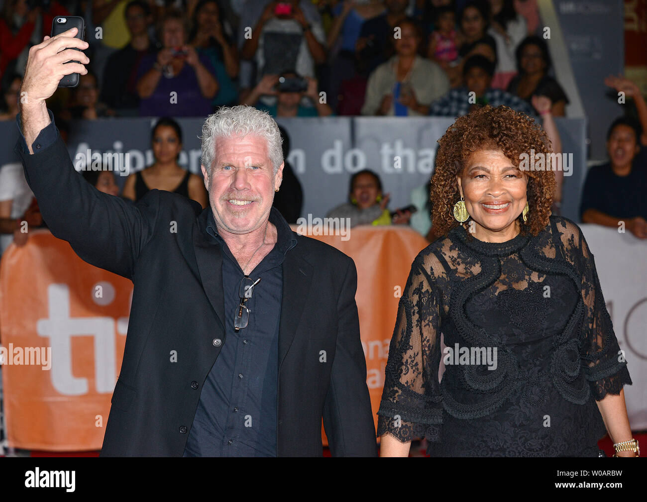 Ron Perlman films the event on his cellphone as he arrives with his ...
