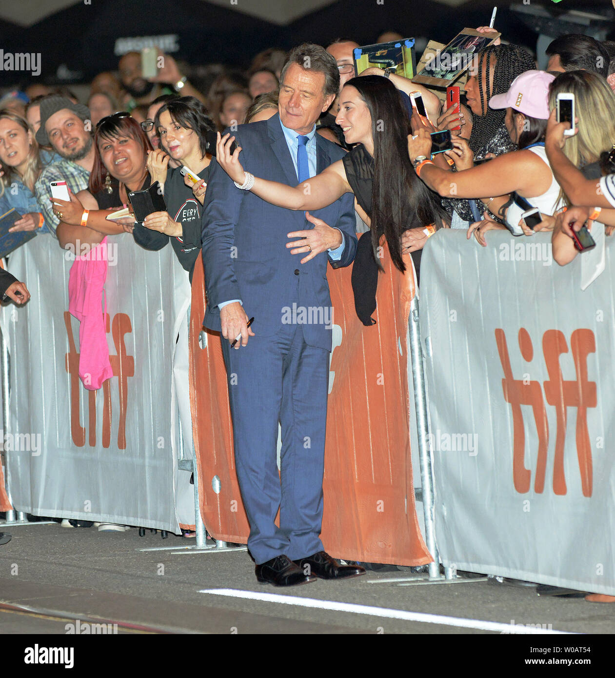 Bryan Cranston poses for selfies with fans as he arrives at the Toronto ...